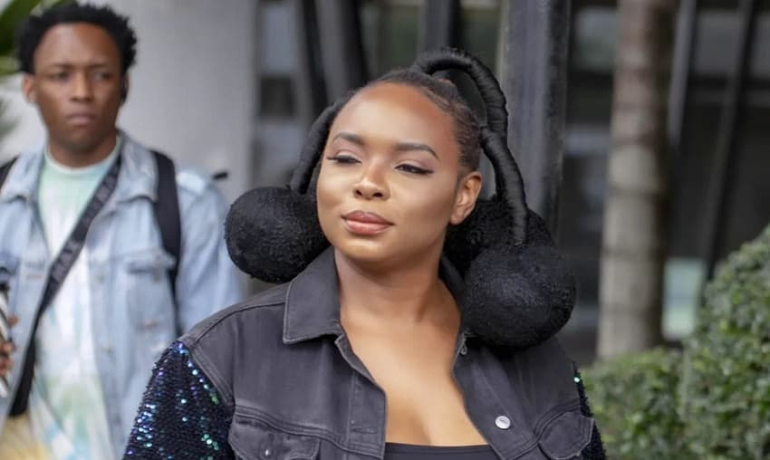 Yemi Alade Wore Ankara Cape Jumpsuit and Cute Puffballs Hairstyle at ...